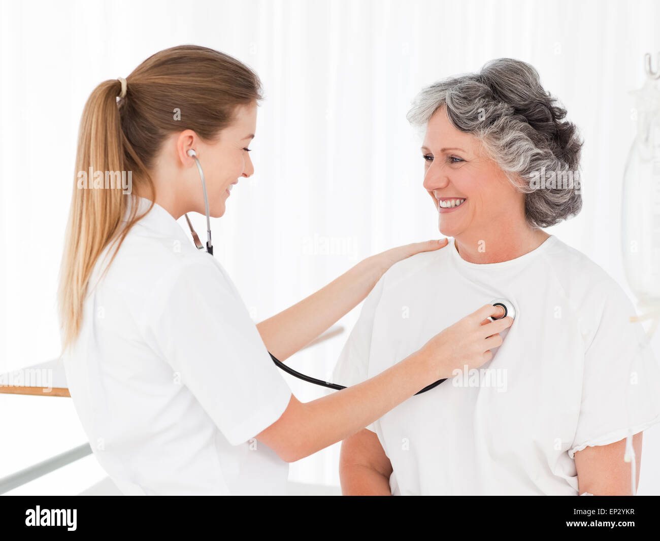 Nurse taking the heartbeat of her patient Stock Photo - Alamy