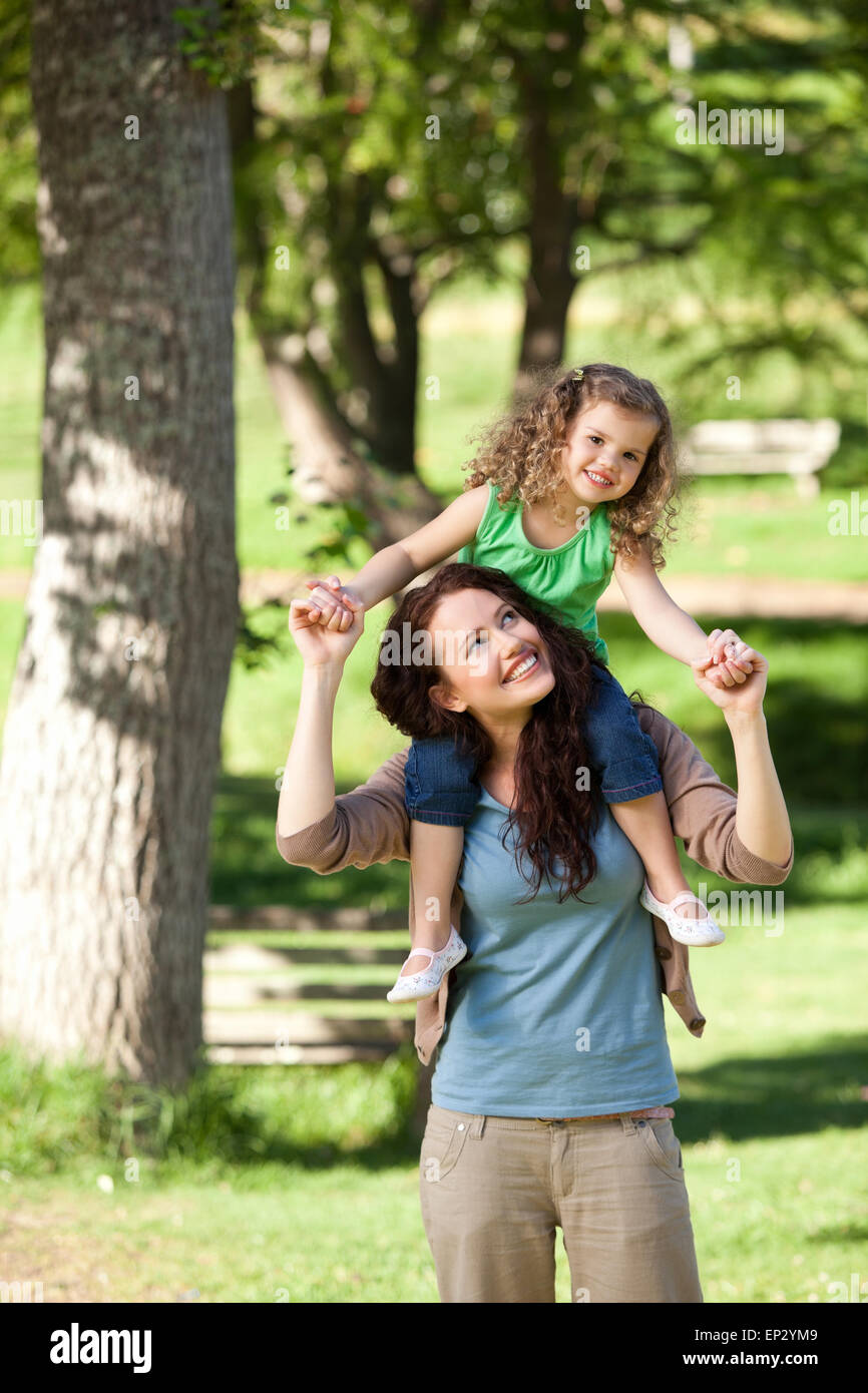 Mother giving daughter a piggyback Stock Photo - Alamy
