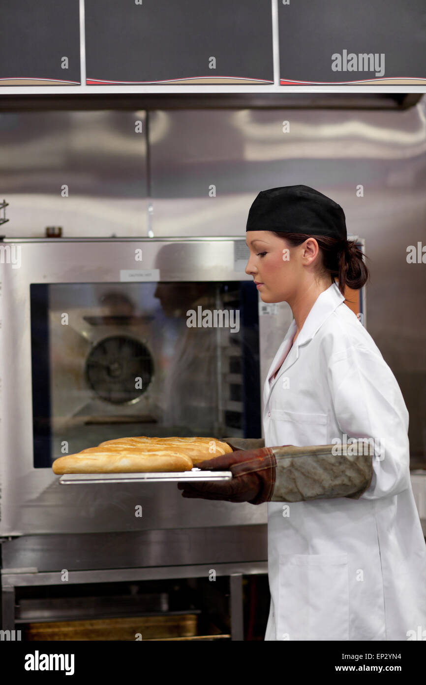 Charming young baker with baguettes Stock Photo - Alamy