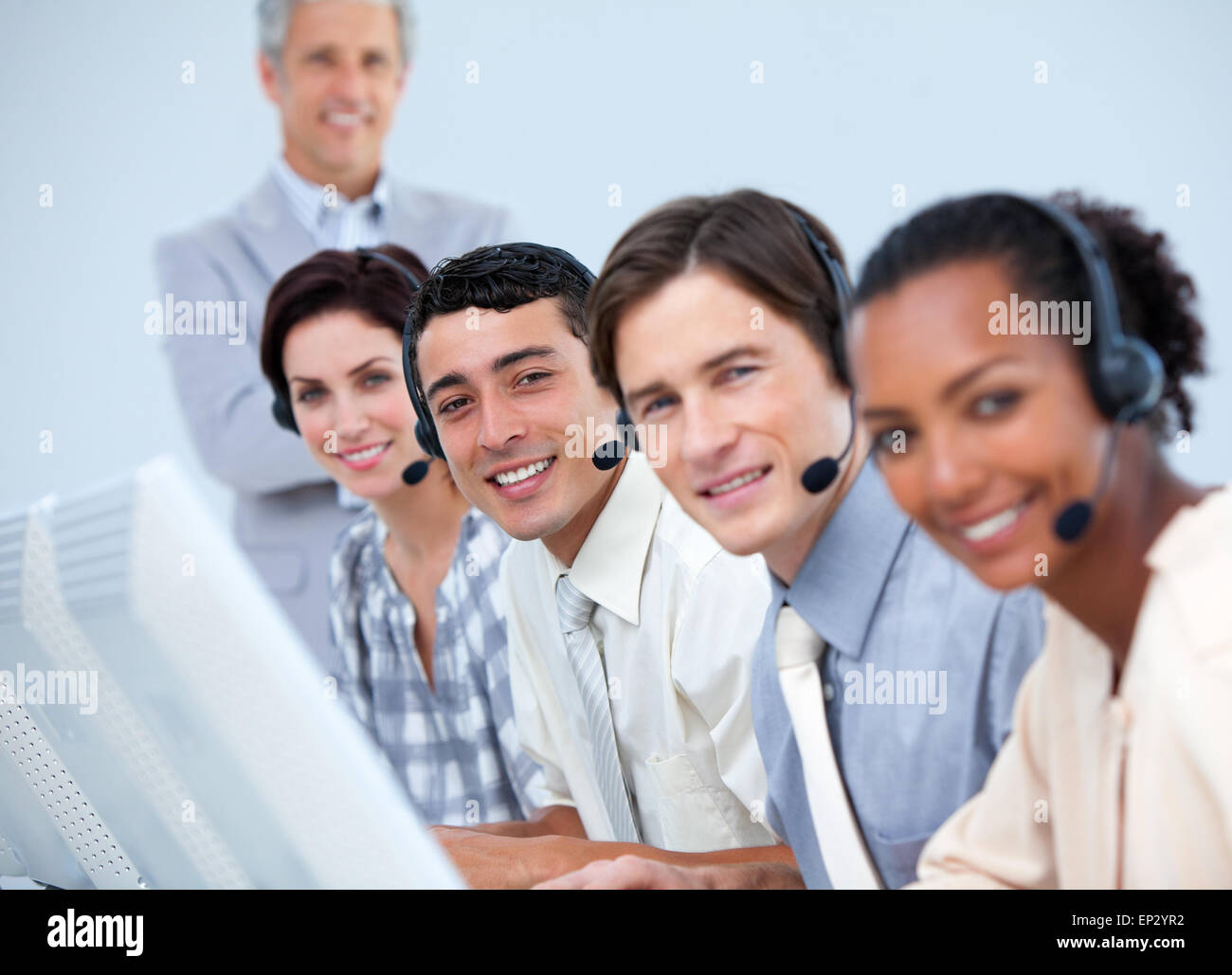 Cheerful business partners working in a call center Stock Photo - Alamy