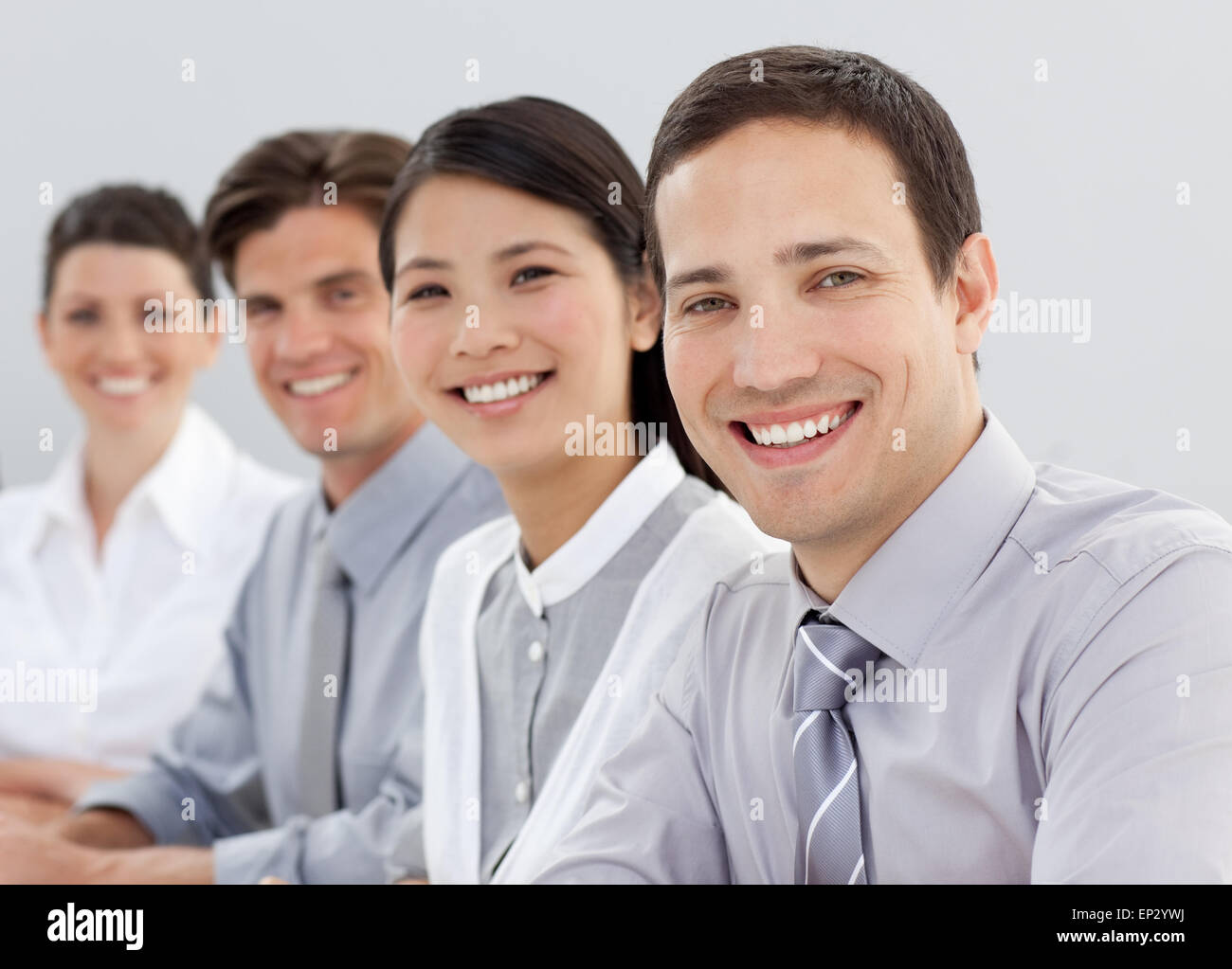 Young business people sitting in a line Stock Photo - Alamy