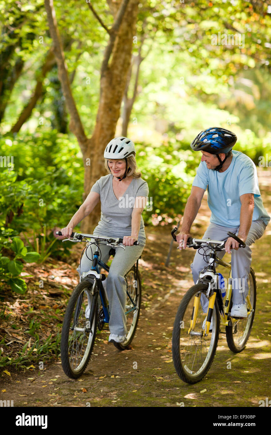 Elderly couple mountain biking outside Stock Photo - Alamy