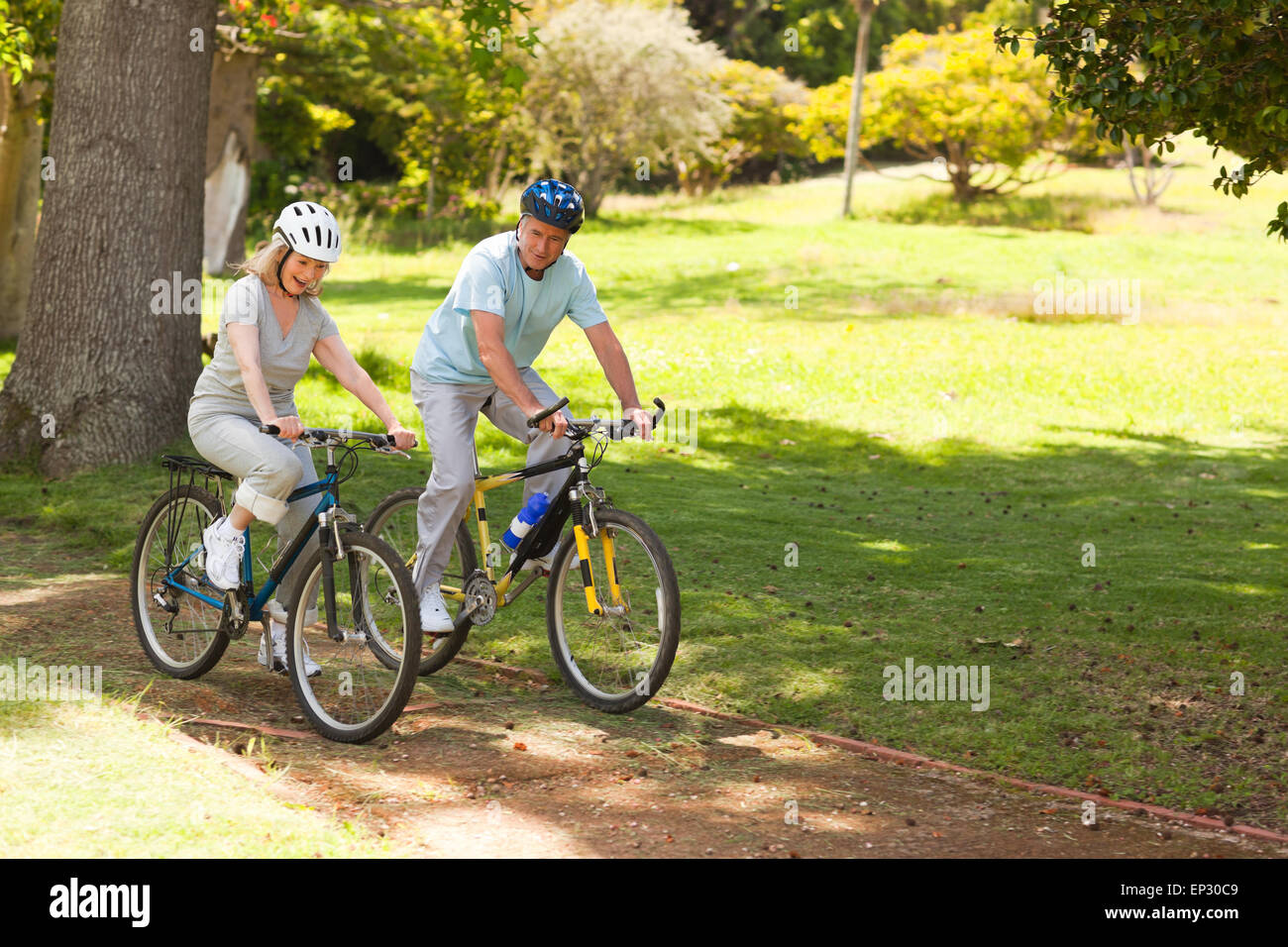 Retired couple mountain biking outside Stock Photo - Alamy
