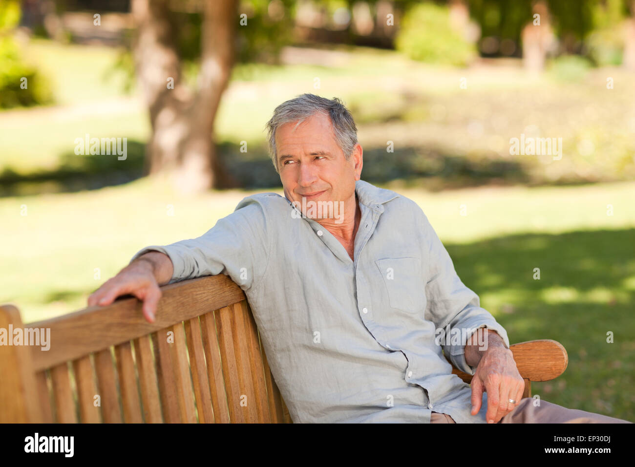 Senior man sitting on a bench Stock Photo - Alamy