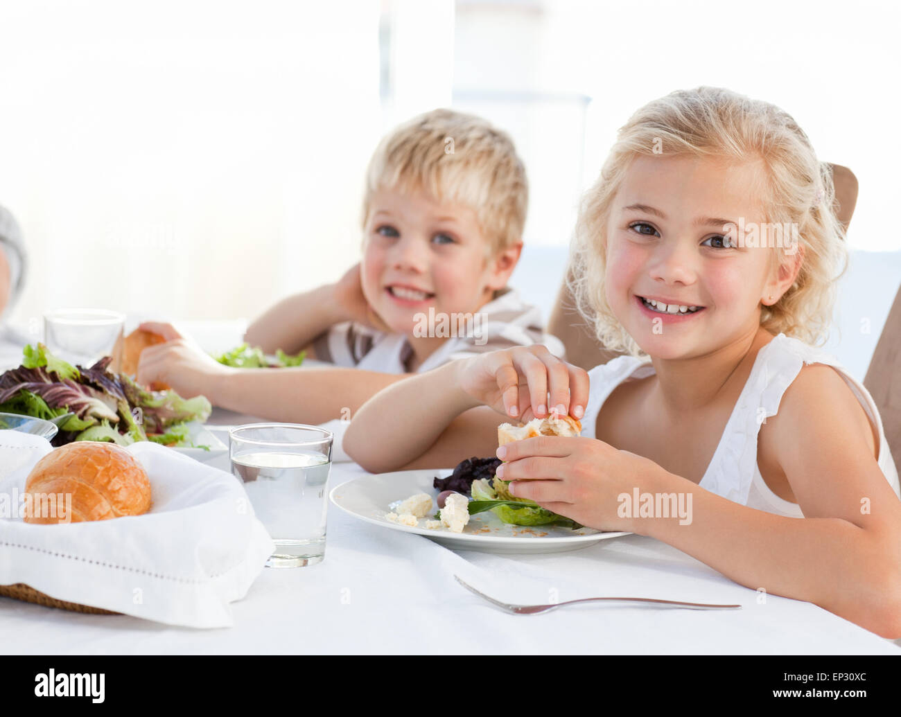 Happy children at the table Stock Photo - Alamy