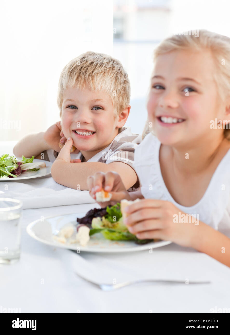 Happy children at the table Stock Photo - Alamy