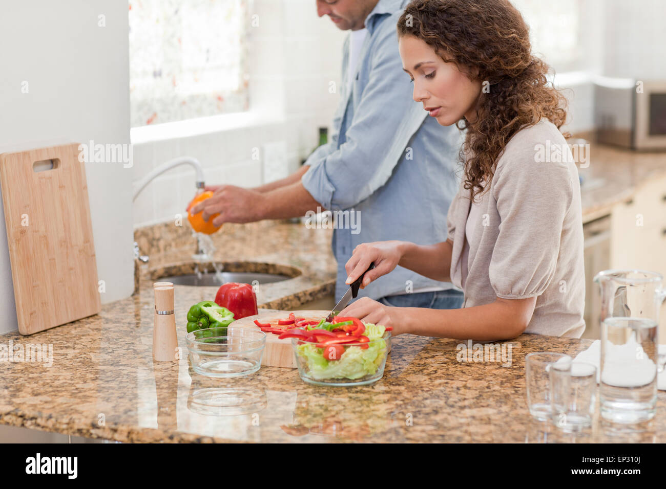 Handsome man cooking with his girlfriend Stock Photo - Alamy