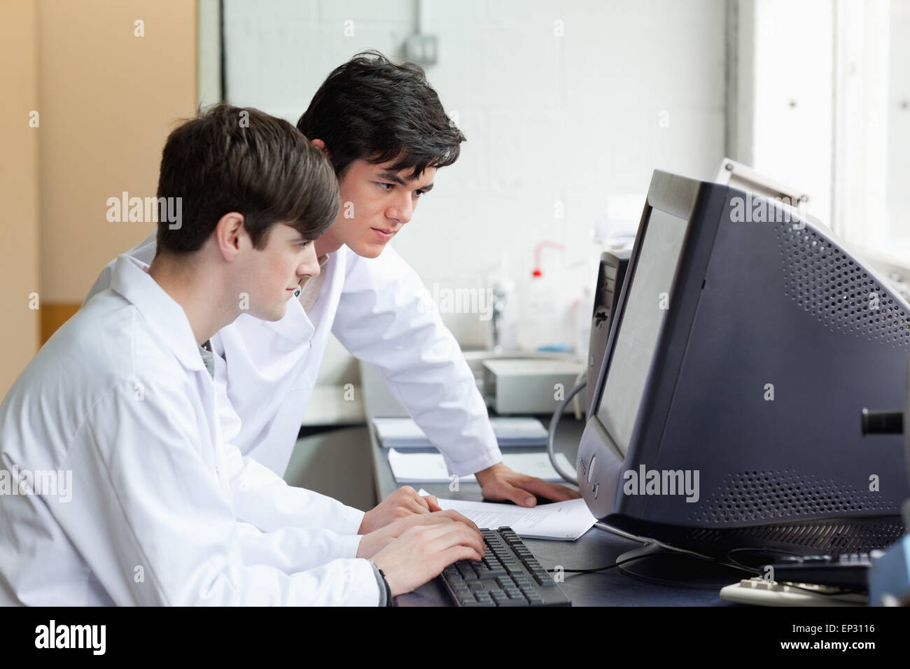 Scientists working with a monitor Stock Photo - Alamy