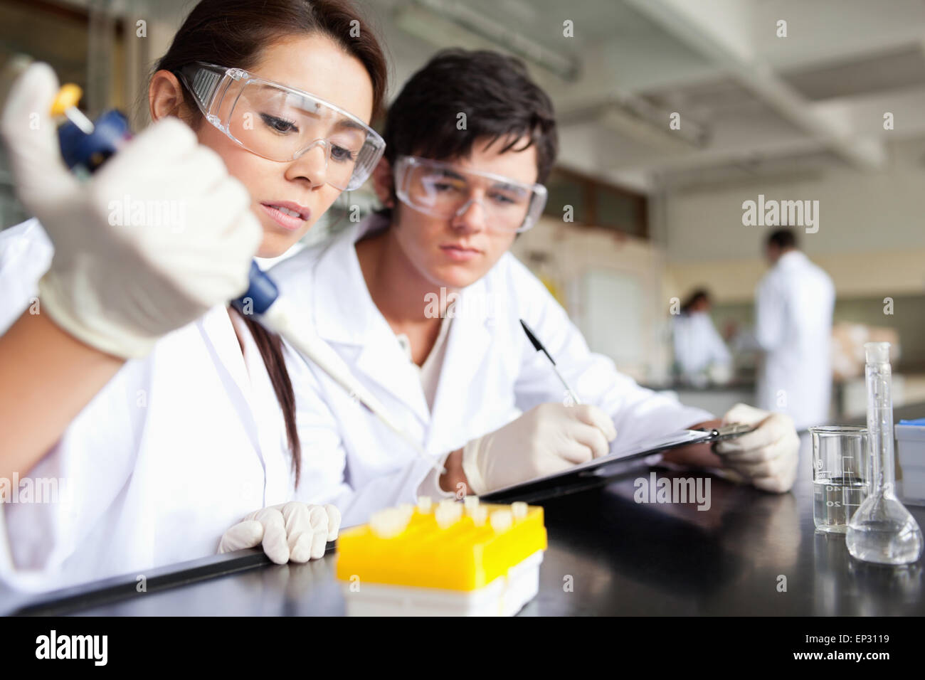 Focused scientists making an experiment Stock Photo - Alamy