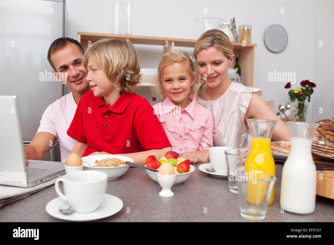 Jolly family having breakfast together Stock Photo - Alamy