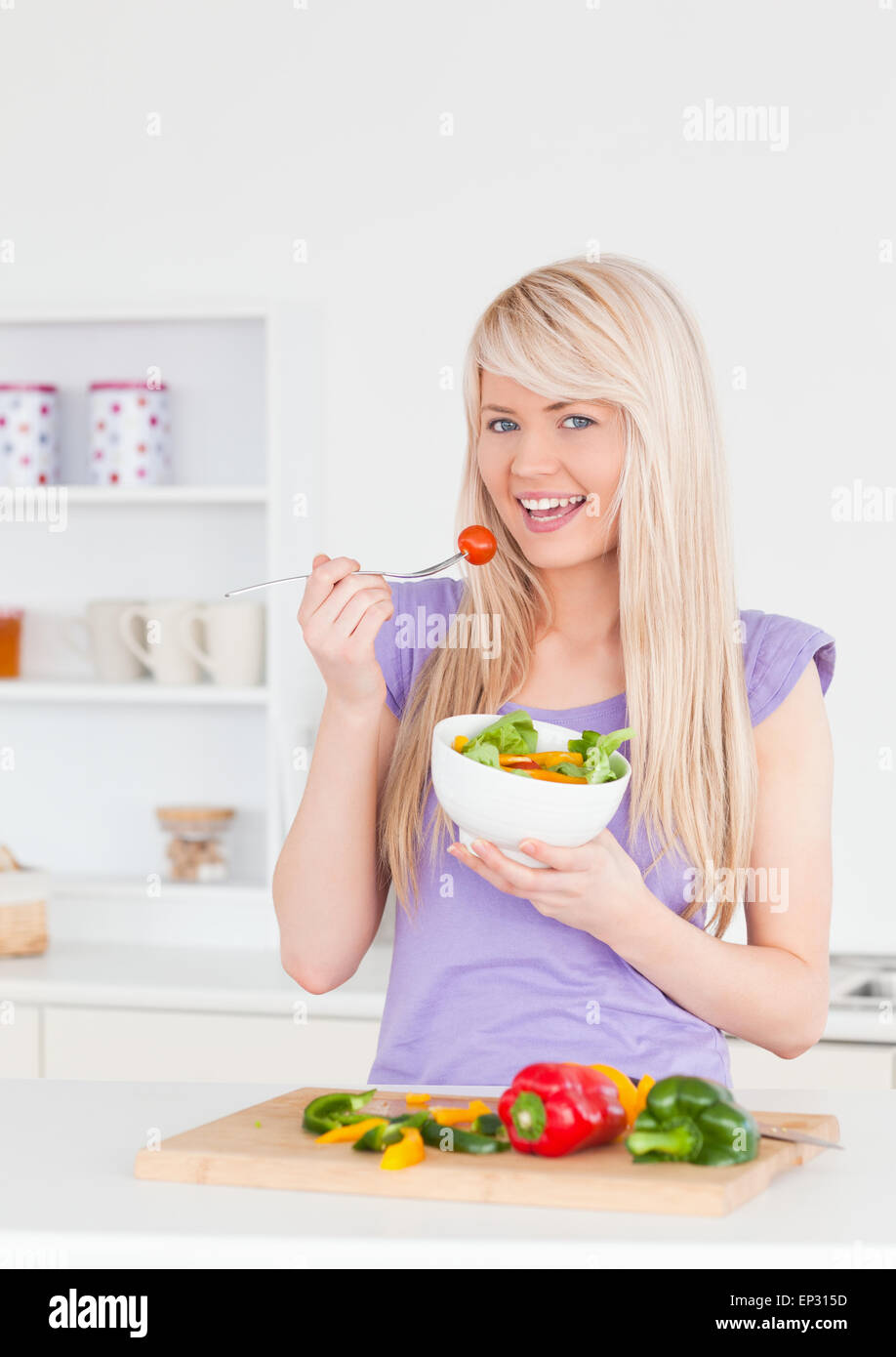 Blonde smiling woman eating her salad Stock Photo - Alamy