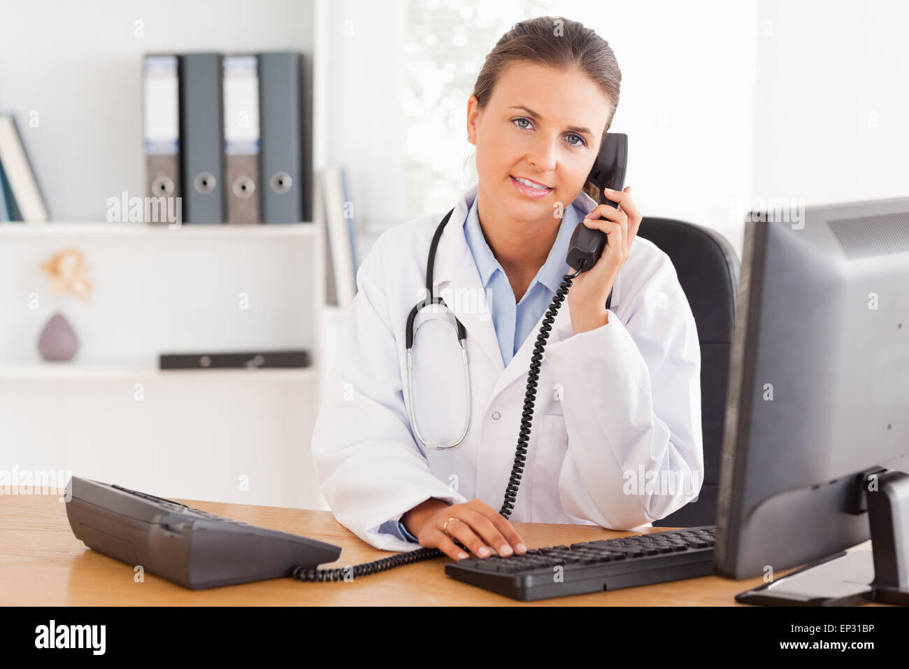 Serious female doctor on the phone Stock Photo - Alamy Serious female doctor on the phone Stock Photo - Alamy