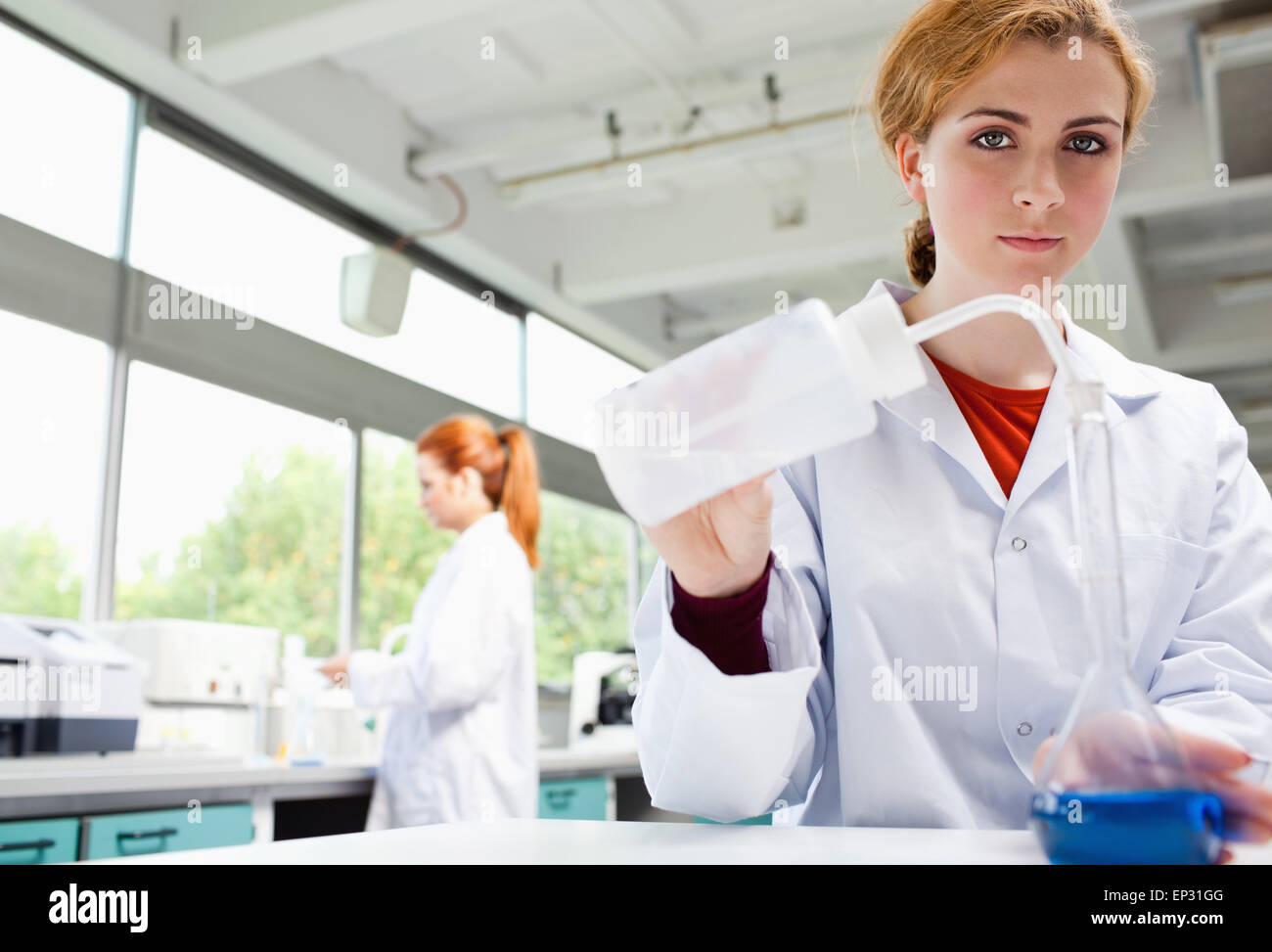 Female science students working Stock Photo - Alamy
