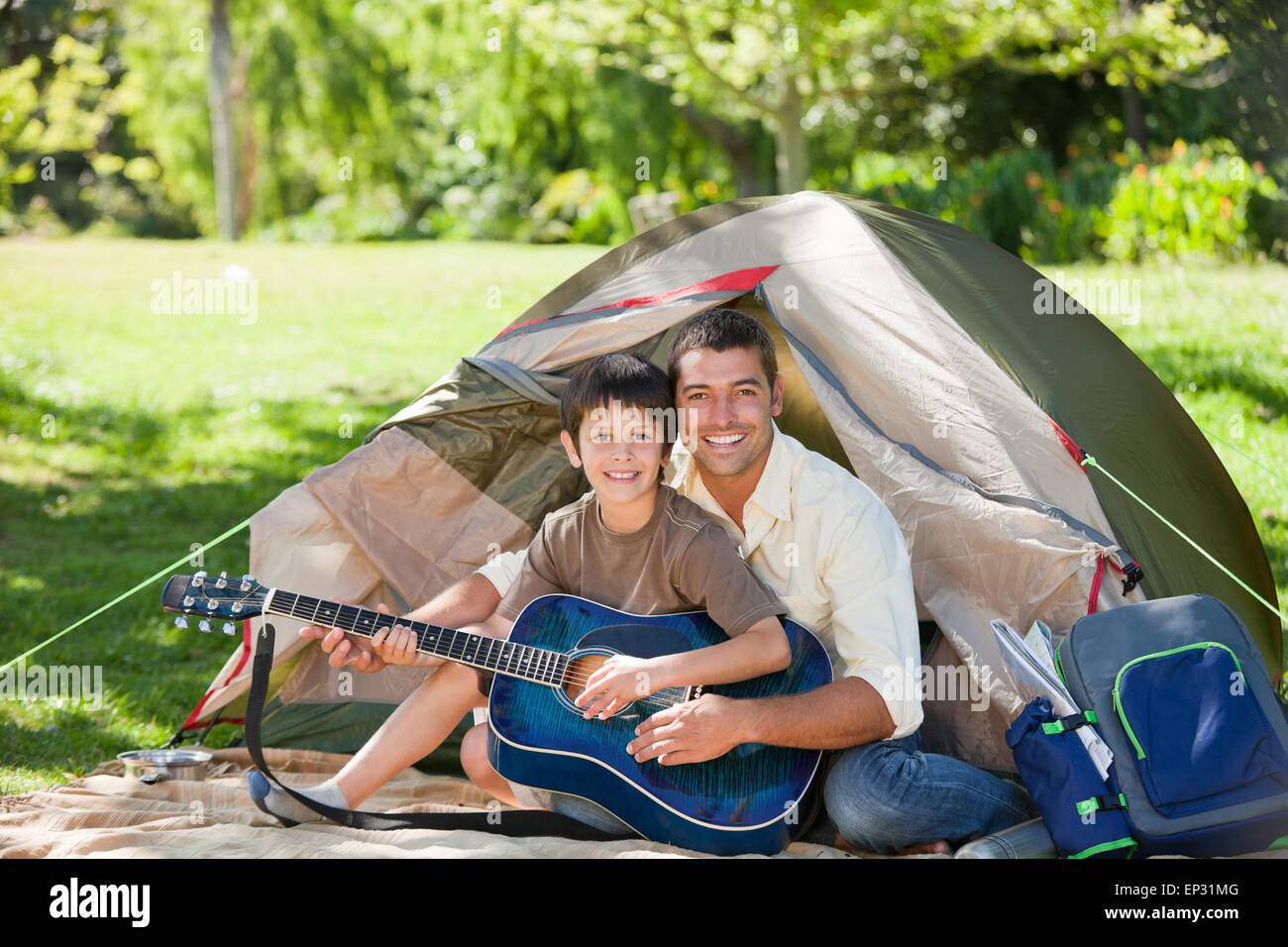 Father playing guitar with his son Stock Photo - Alamy