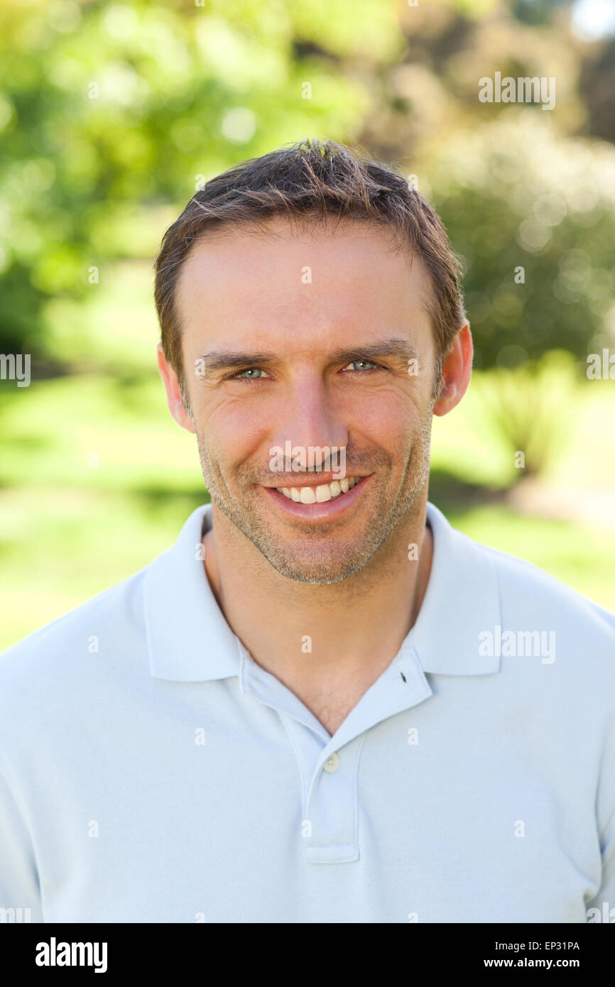 Man smiling in the park Stock Photo - Alamy