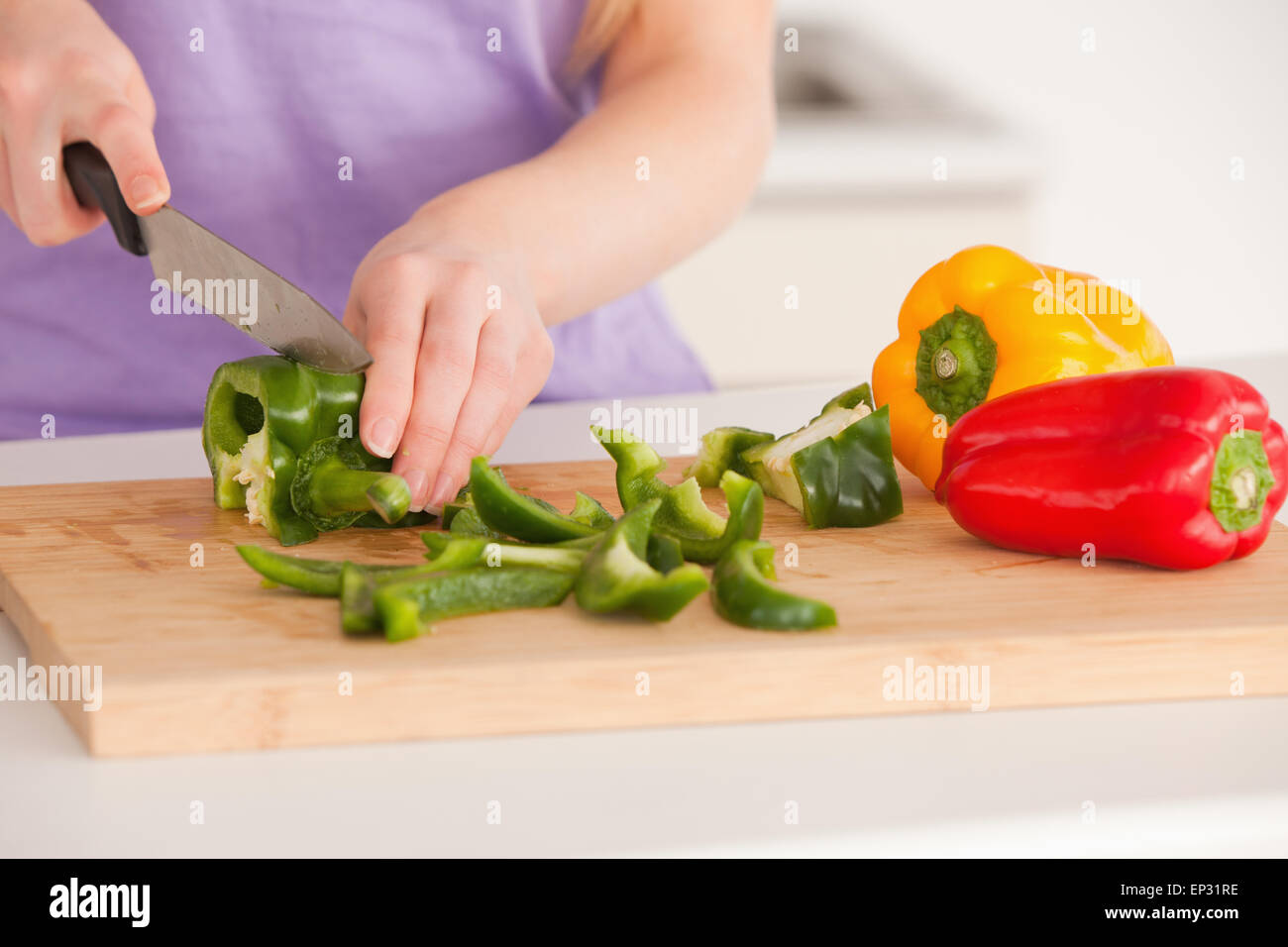 Woman cutting vegetables in modern kitchen interior Stock Photo - Alamy