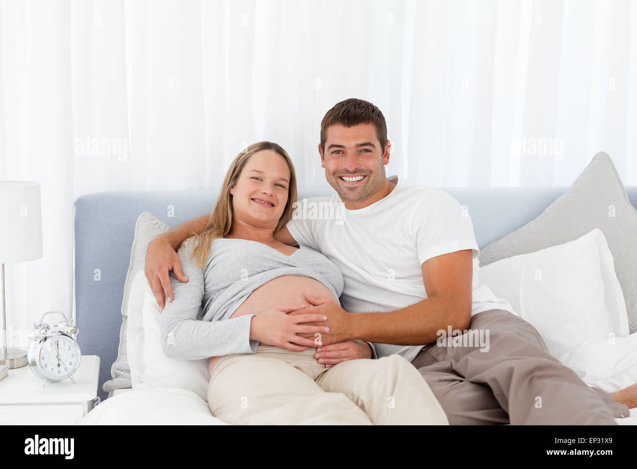 Attentive man touching the belly of his wife Stock Photo - Alamy