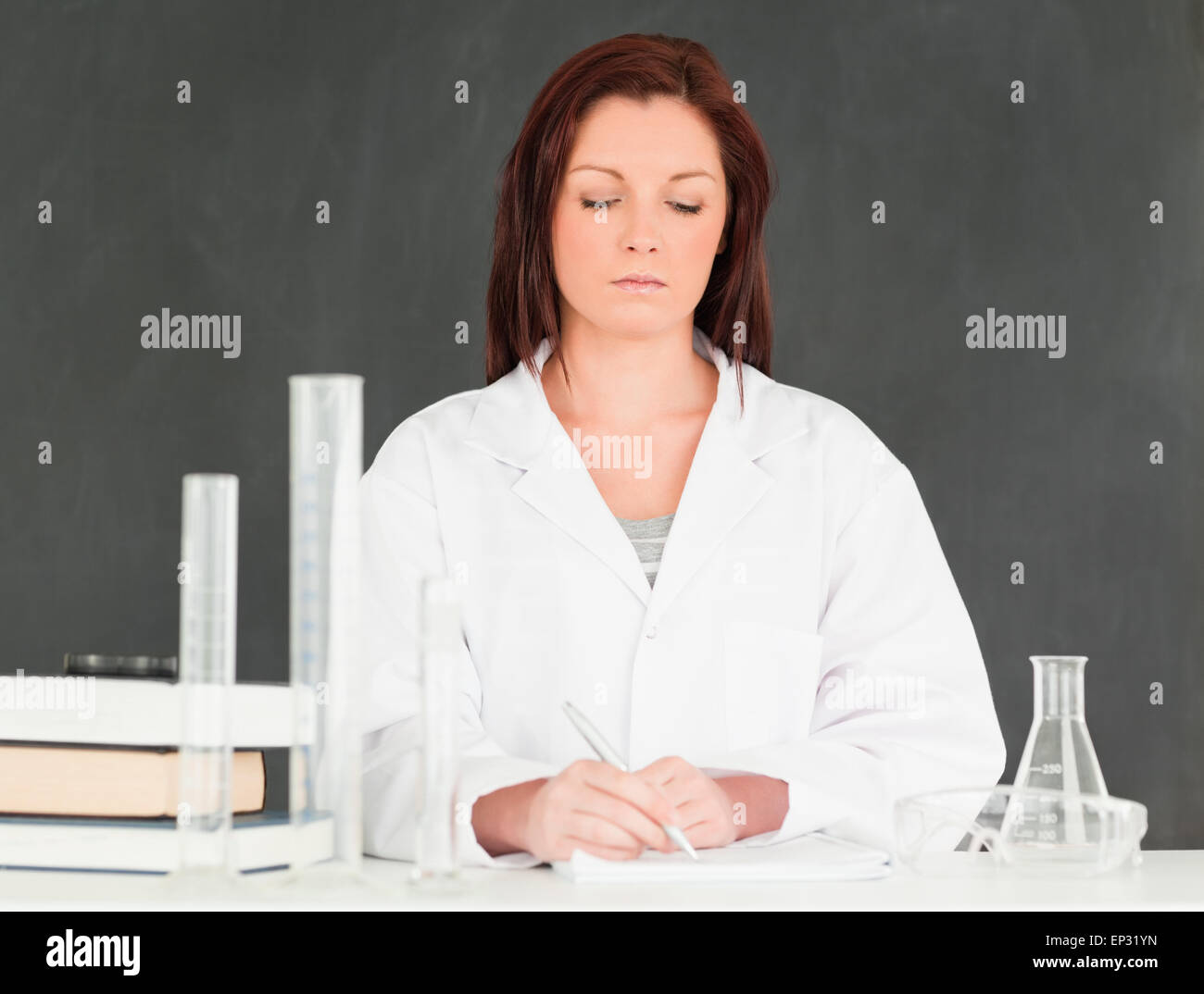 Serious scientist taking notes Stock Photo - Alamy
