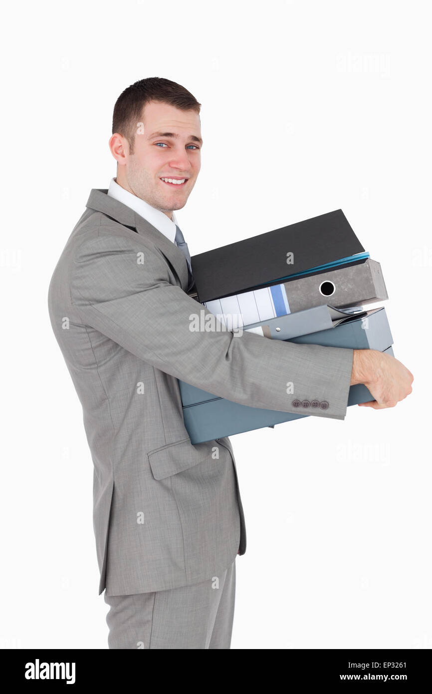 Portrait of a young businessman holding a stack of binders Stock Photo ...