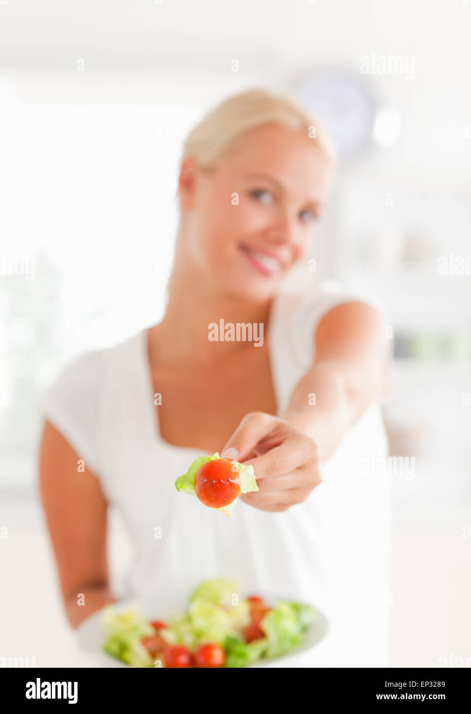 Portrait of a woman giving a tomato Stock Photo - Alamy