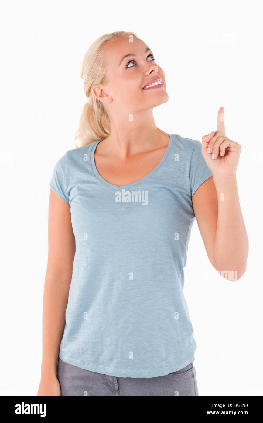 Smiling cute woman pointing at copyspace Stock Photo - Alamy