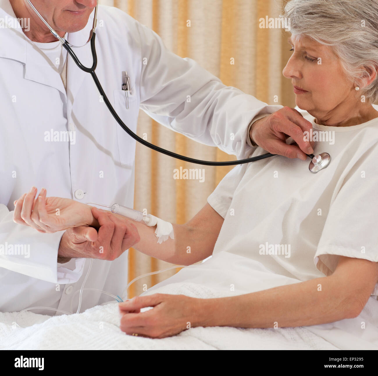Senior doctor taking the heartbeat of his patient Stock Photo - Alamy