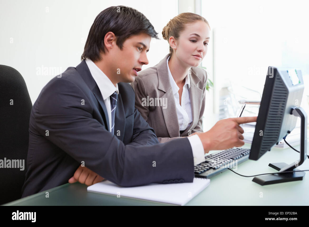 Good looking business people working with a computer Stock Photo - Alamy