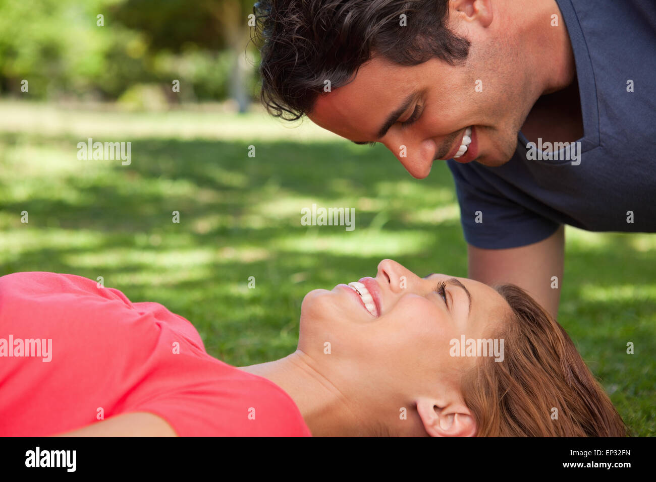 Man smiling as he looks down into his friends eyes Stock Photo - Alamy