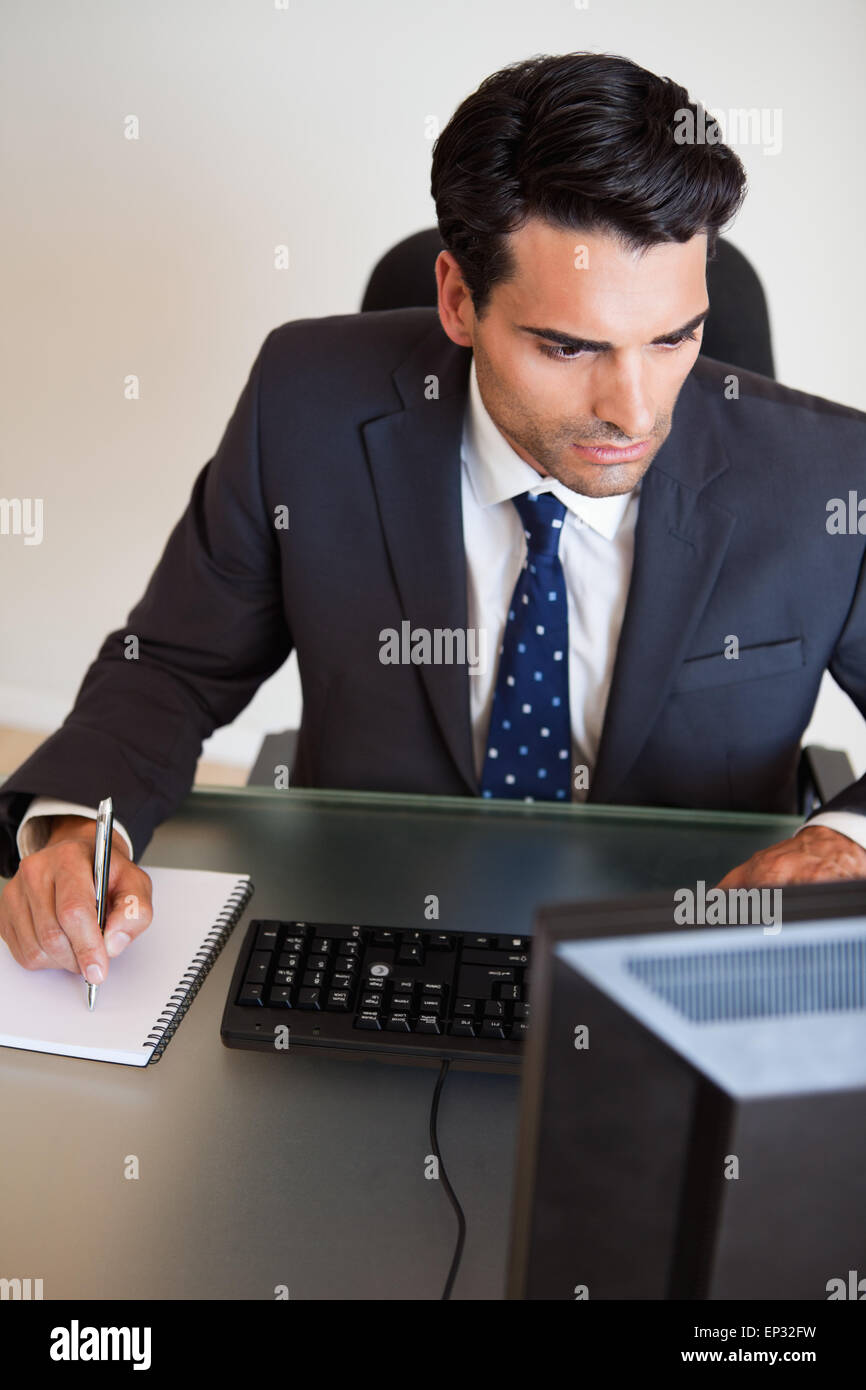 Portrait of a serious businessman taking notes Stock Photo - Alamy