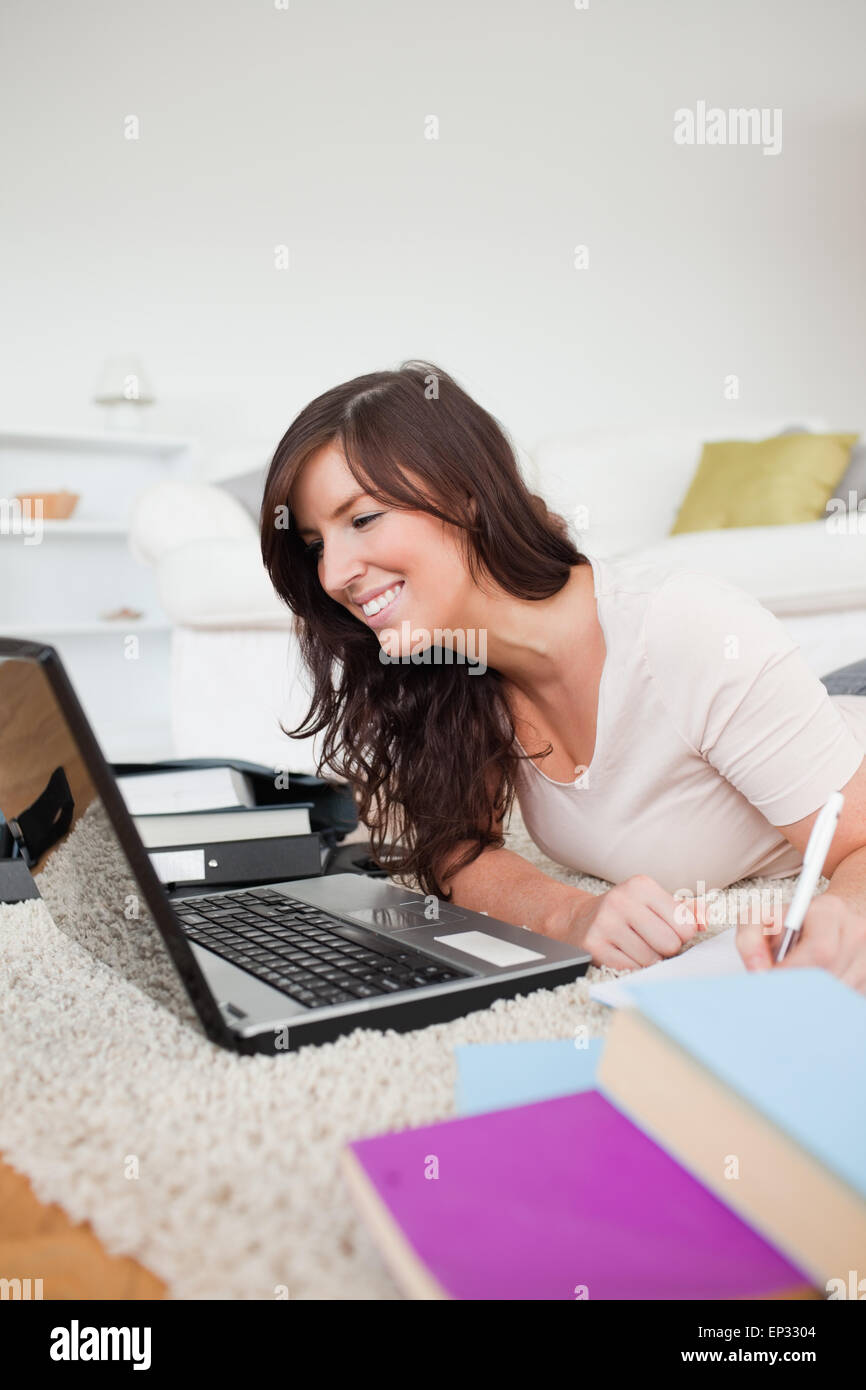 Young beautiful woman relaxing with her laptop and posing while writing ...