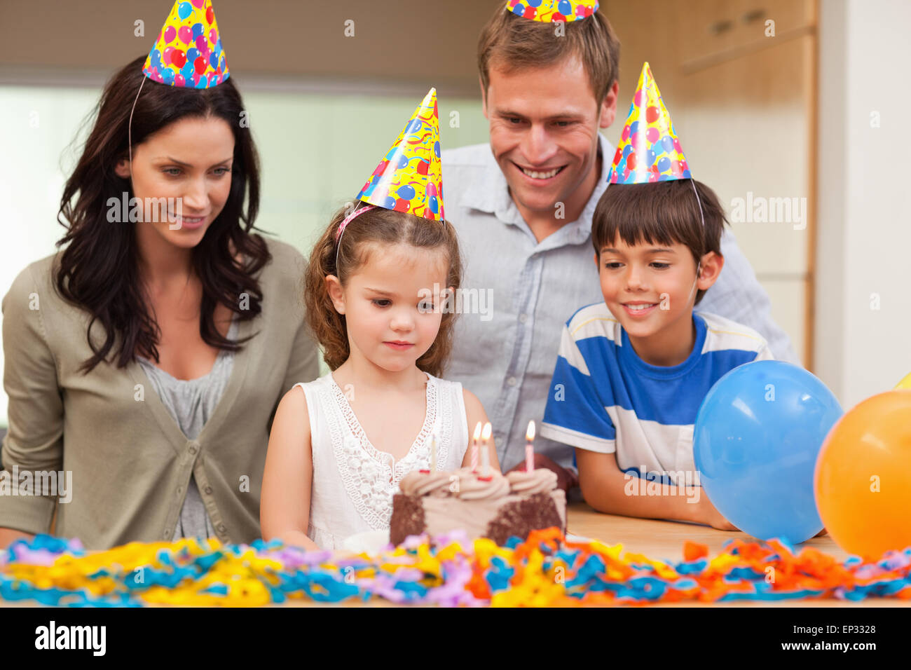 Girl about to blow out the candles on her birthday cake Stock Photo - Alamy
