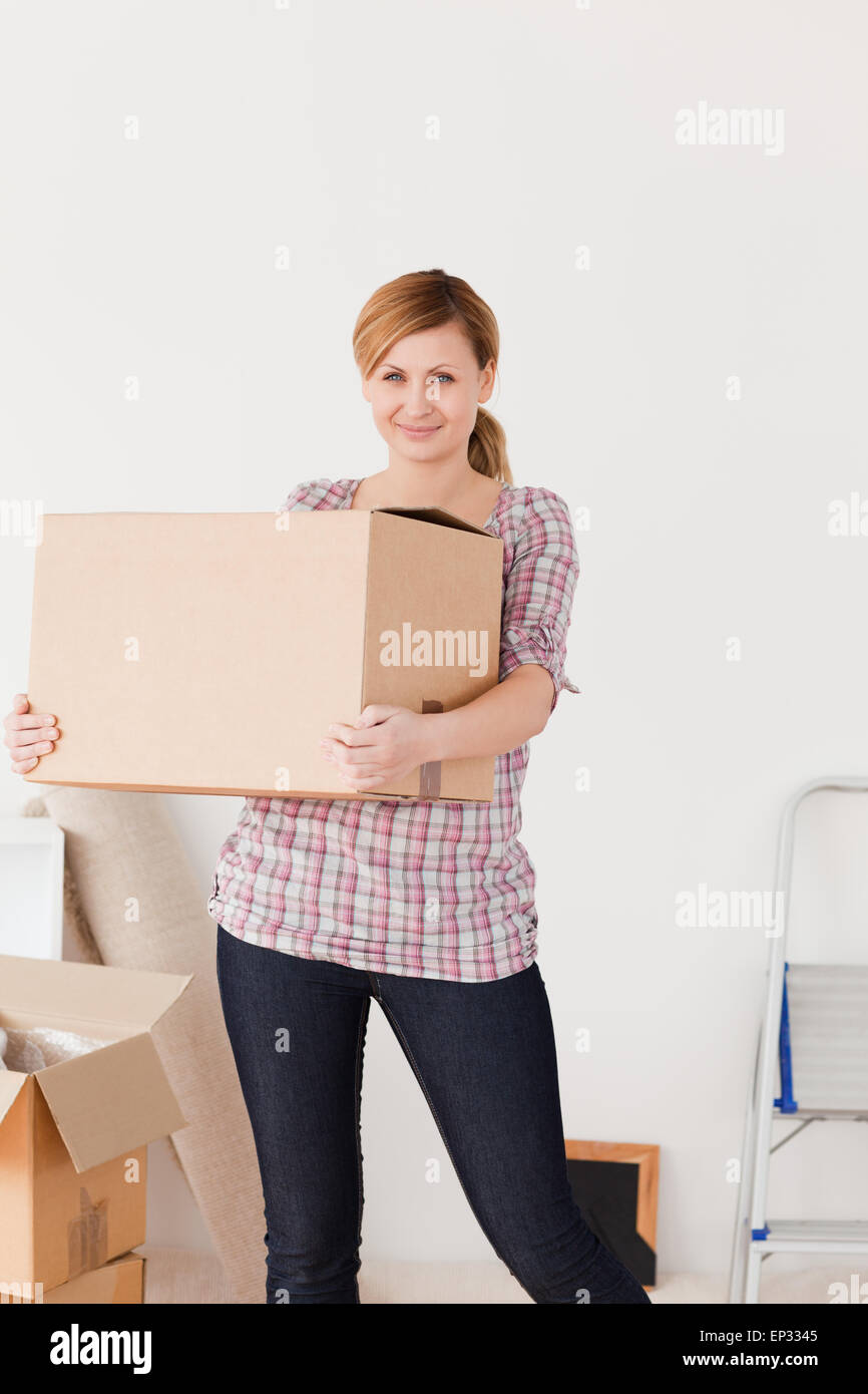 Blonde woman carrying cardboard boxes Stock Photo - Alamy