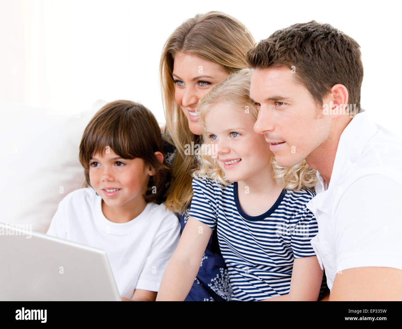 Smiling family surfing on internet Stock Photo - Alamy