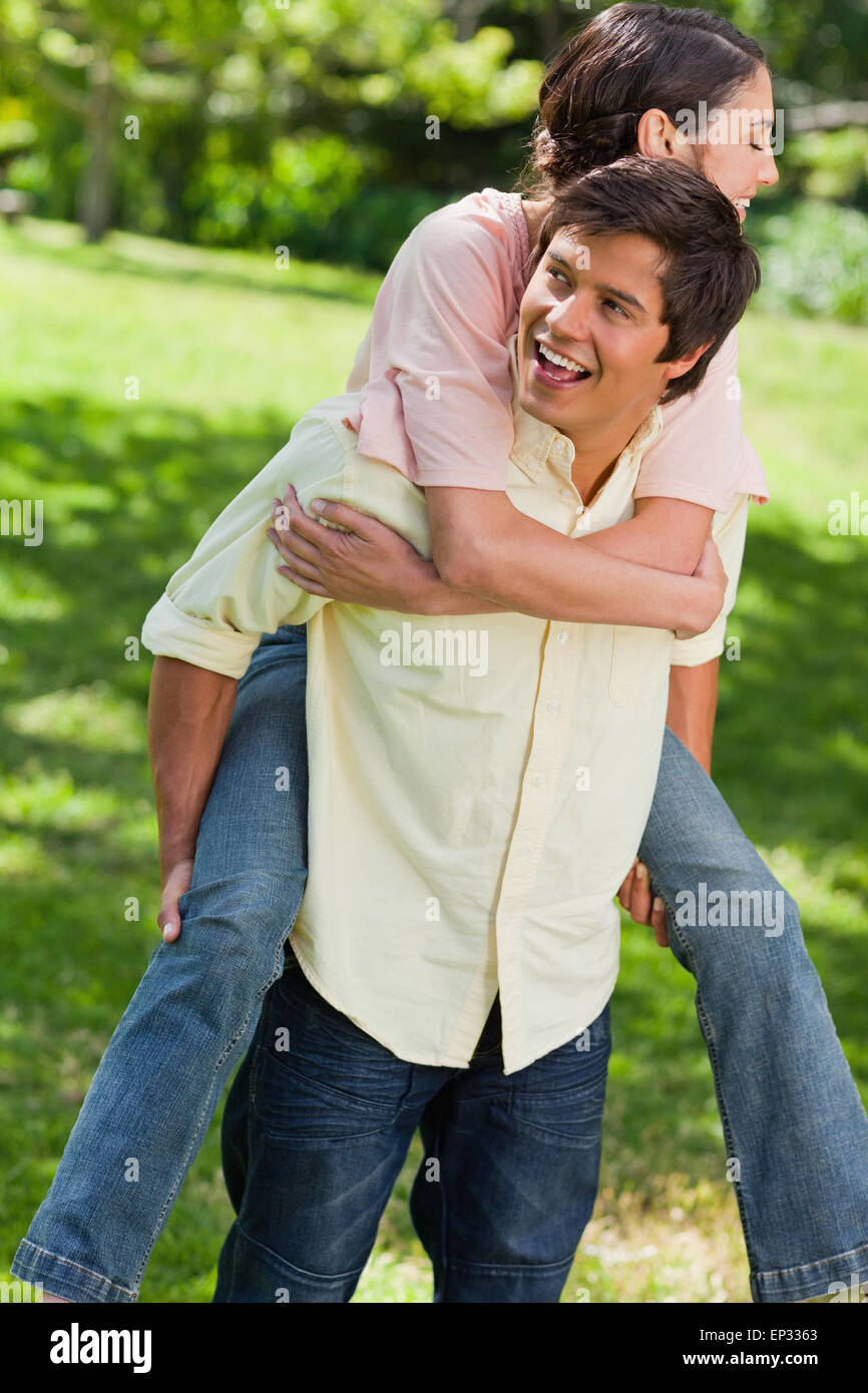 Man looking to his side while carrying his friend on his back Stock ...
