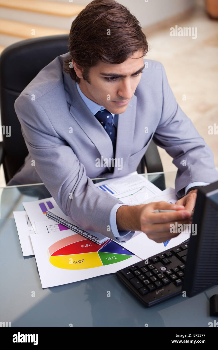 Businessman analyzing statistics Stock Photo - Alamy