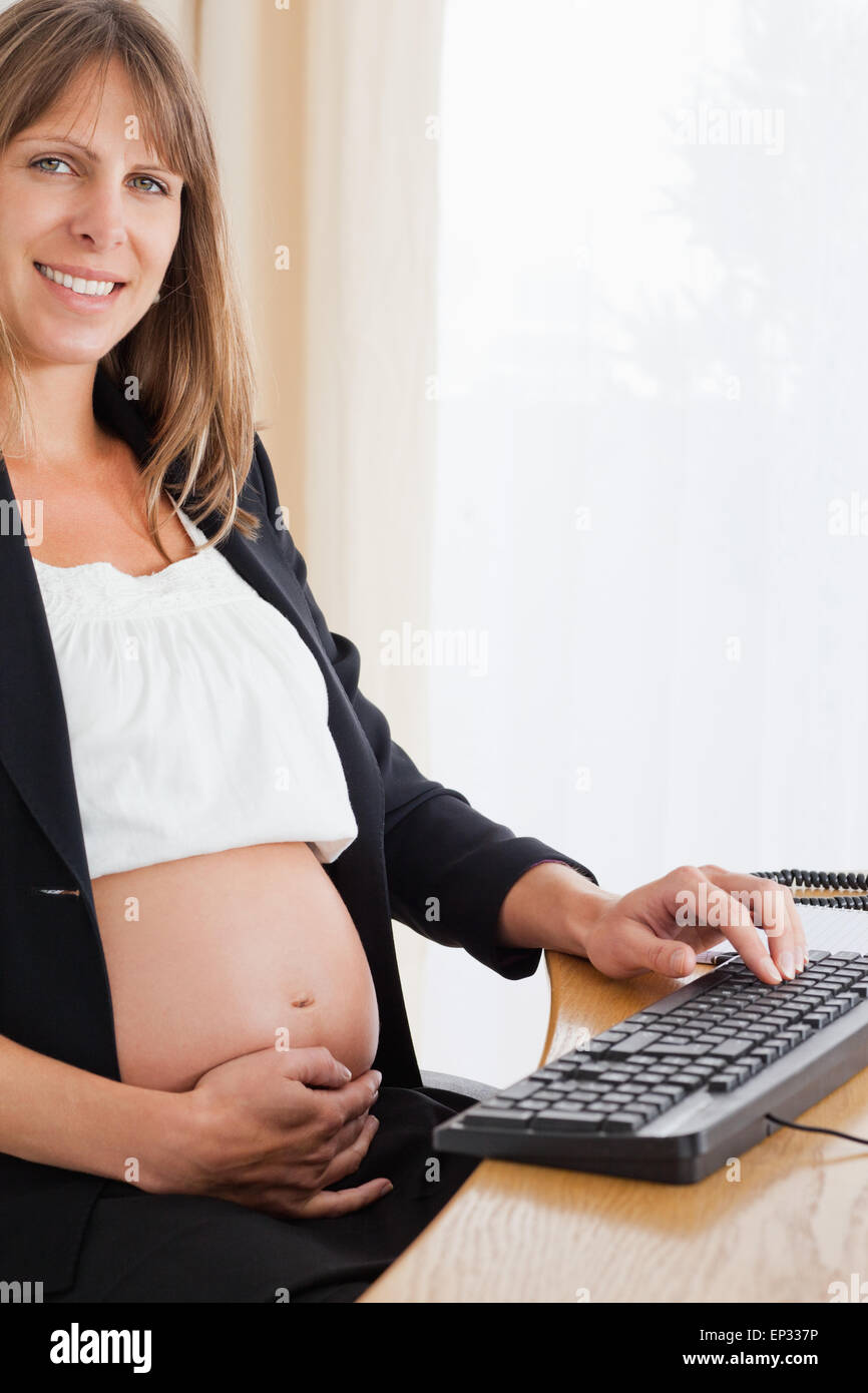 Beautiful pregnant woman working with a computer Stock Photo - Alamy