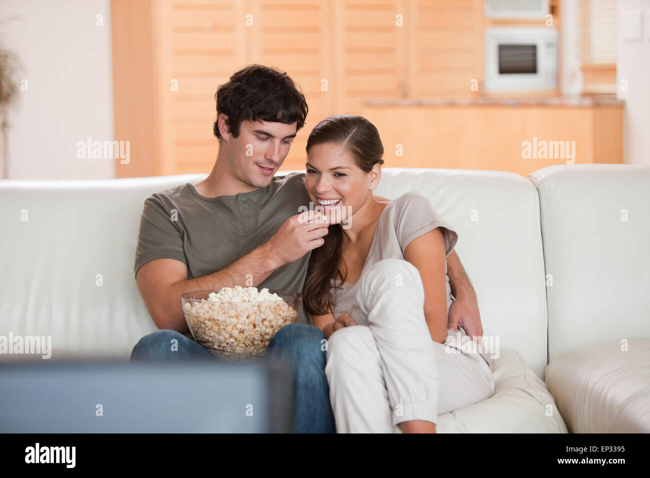 Couple on the couch watching a movie together Stock Photo - Alamy