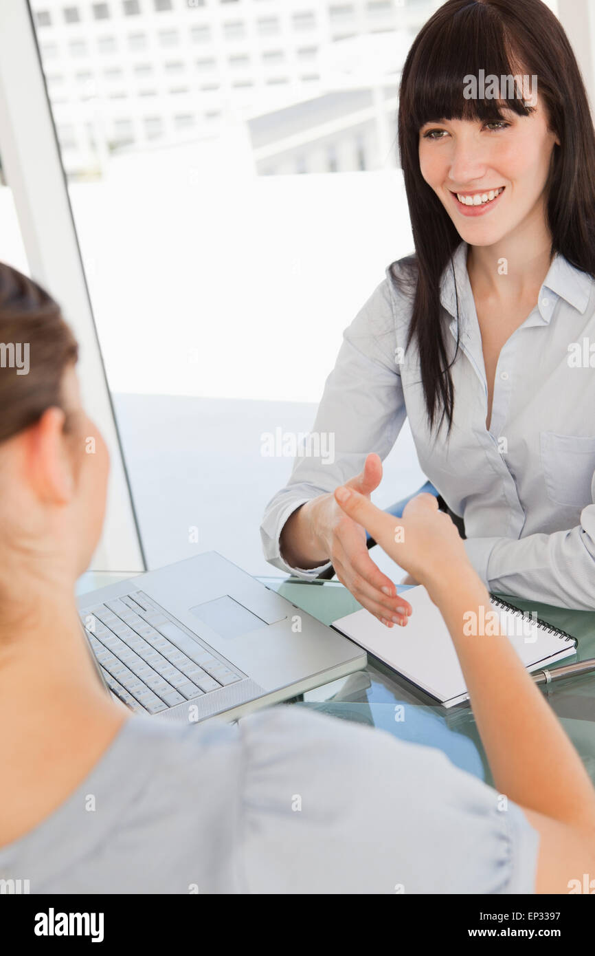 Both women move their hands closer to shake hands Stock Photo - Alamy