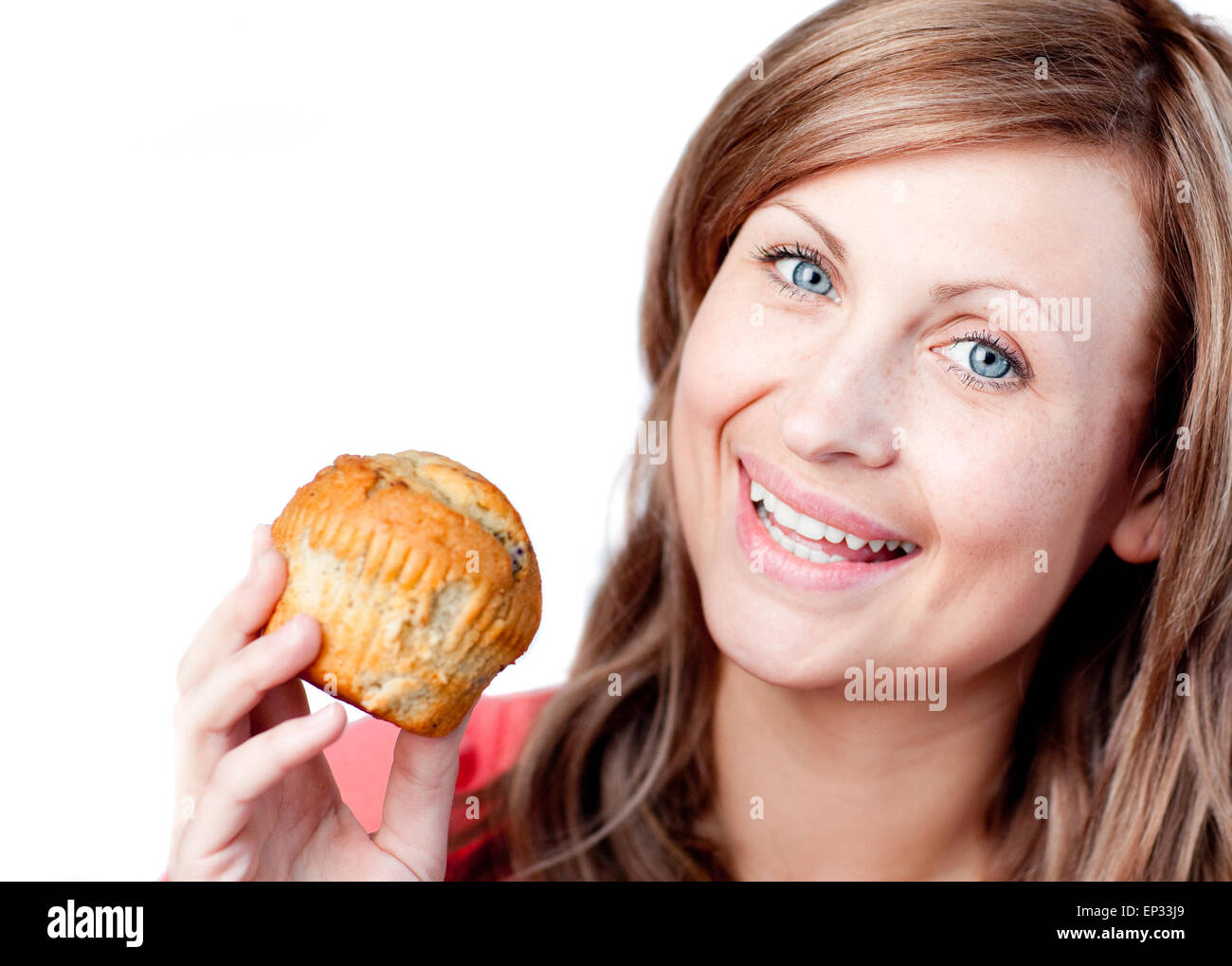Smiling woman is eating a muffin against a white background Stock Photo ...