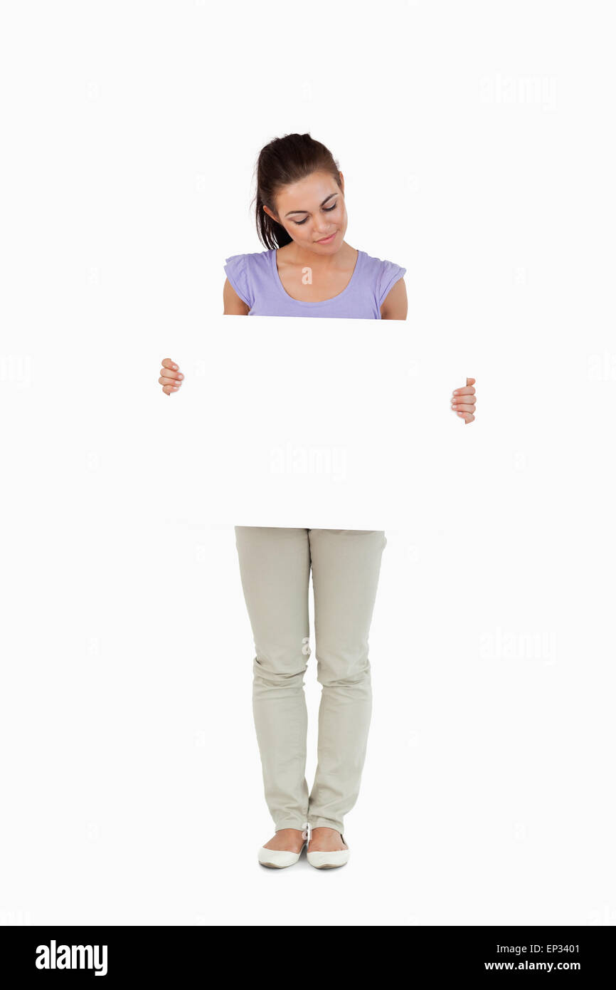 Young female looking at the sign in her hands Stock Photo - Alamy