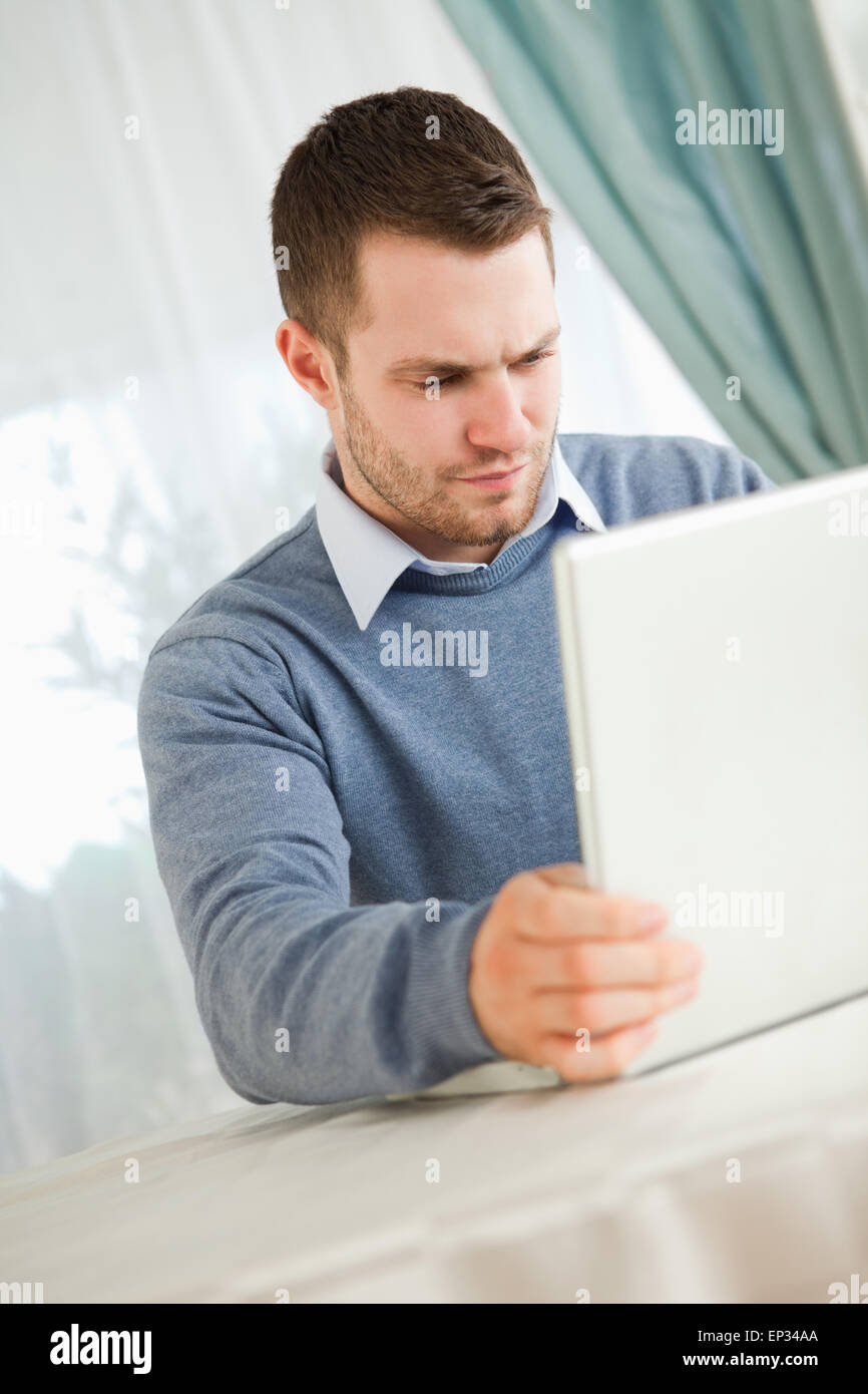 Businessman reading on his laptop Stock Photo - Alamy