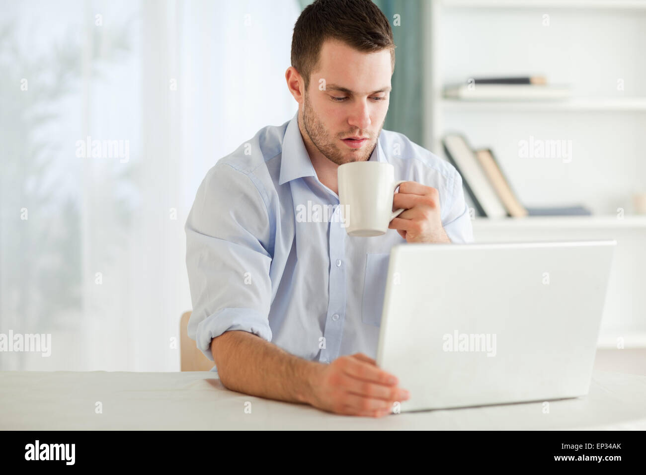 Businessman having a cup of tea Stock Photo - Alamy