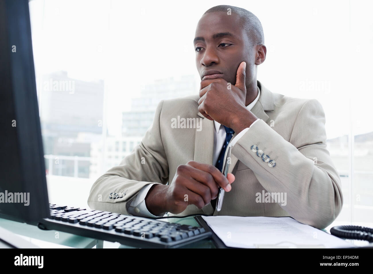 Serious entrepreneur while working with a computer Stock Photo - Alamy