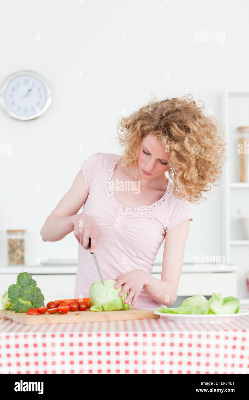 Good looking blonde woman cooking some vegetables in the kitchen Stock ...