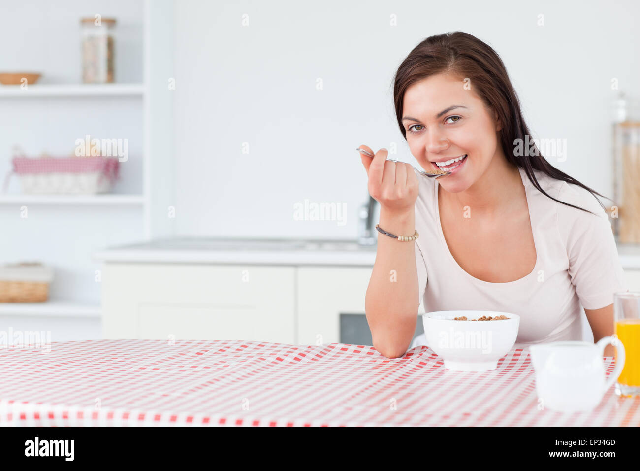 Beautiful woman eating her breakfast Stock Photo - Alamy