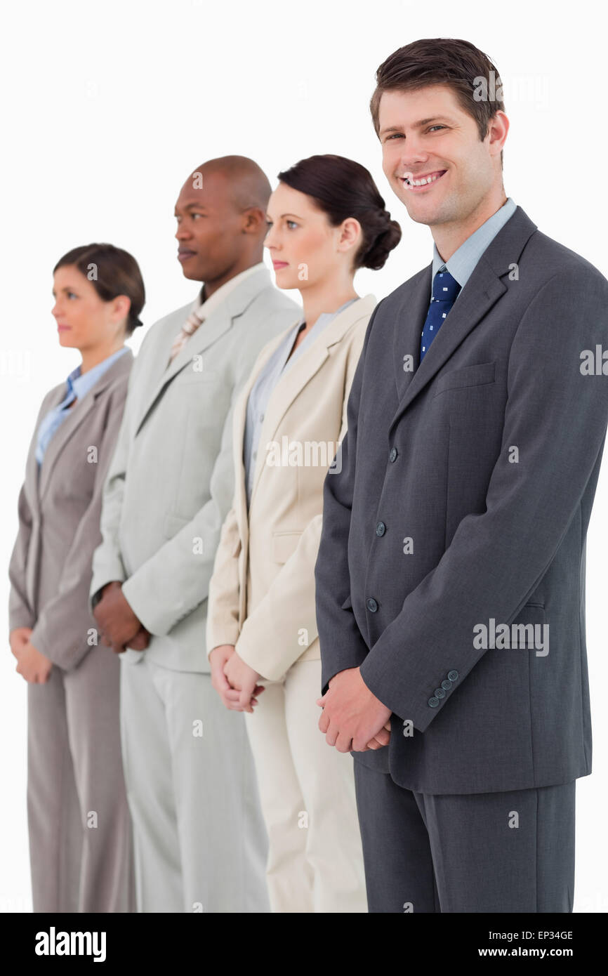 Smiling salesman standing next to his colleagues Stock Photo - Alamy