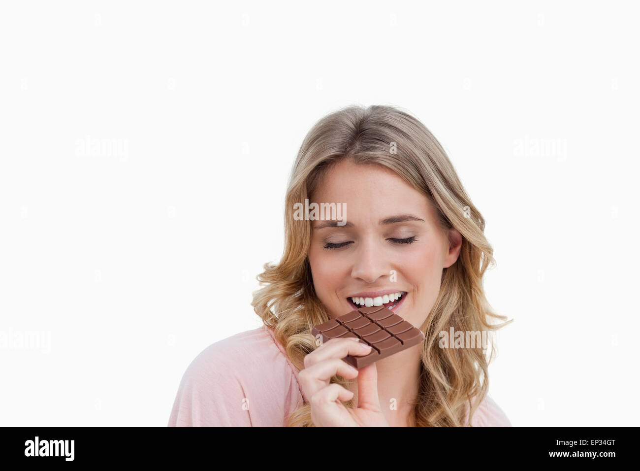 Young woman eating a delicious peace of chocolate Stock Photo - Alamy