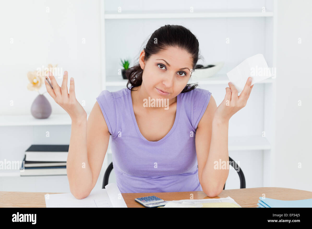 Unenthusiastic young woman accounting Stock Photo - Alamy