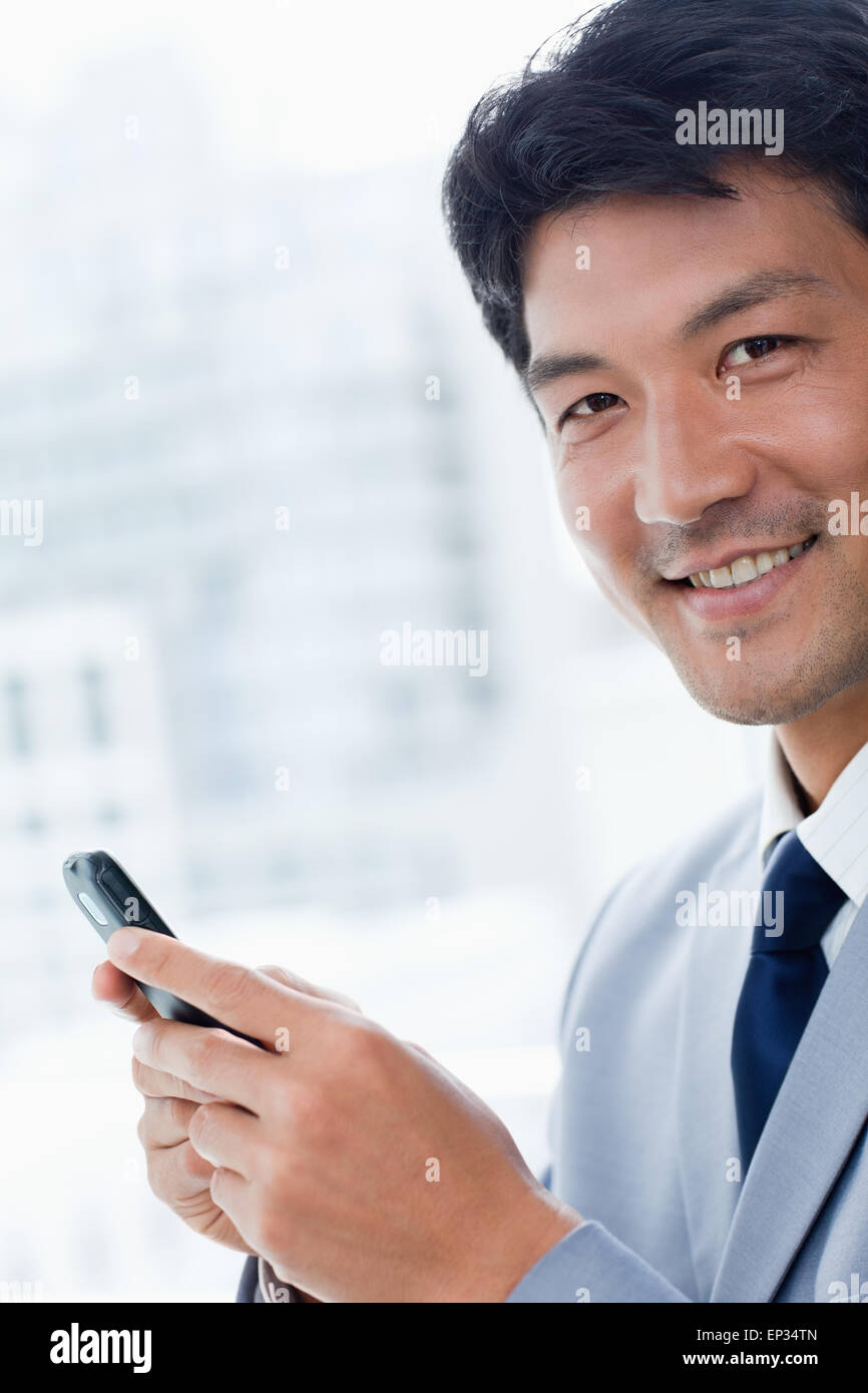 Portrait of a office worker using his mobile phone Stock Photo - Alamy