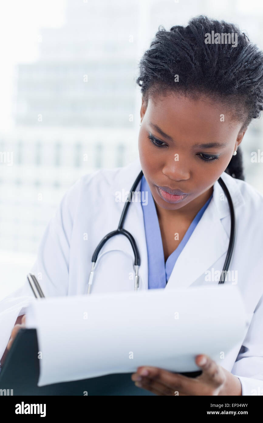 Portrait of a young female doctor signing a document Stock Photo - Alamy